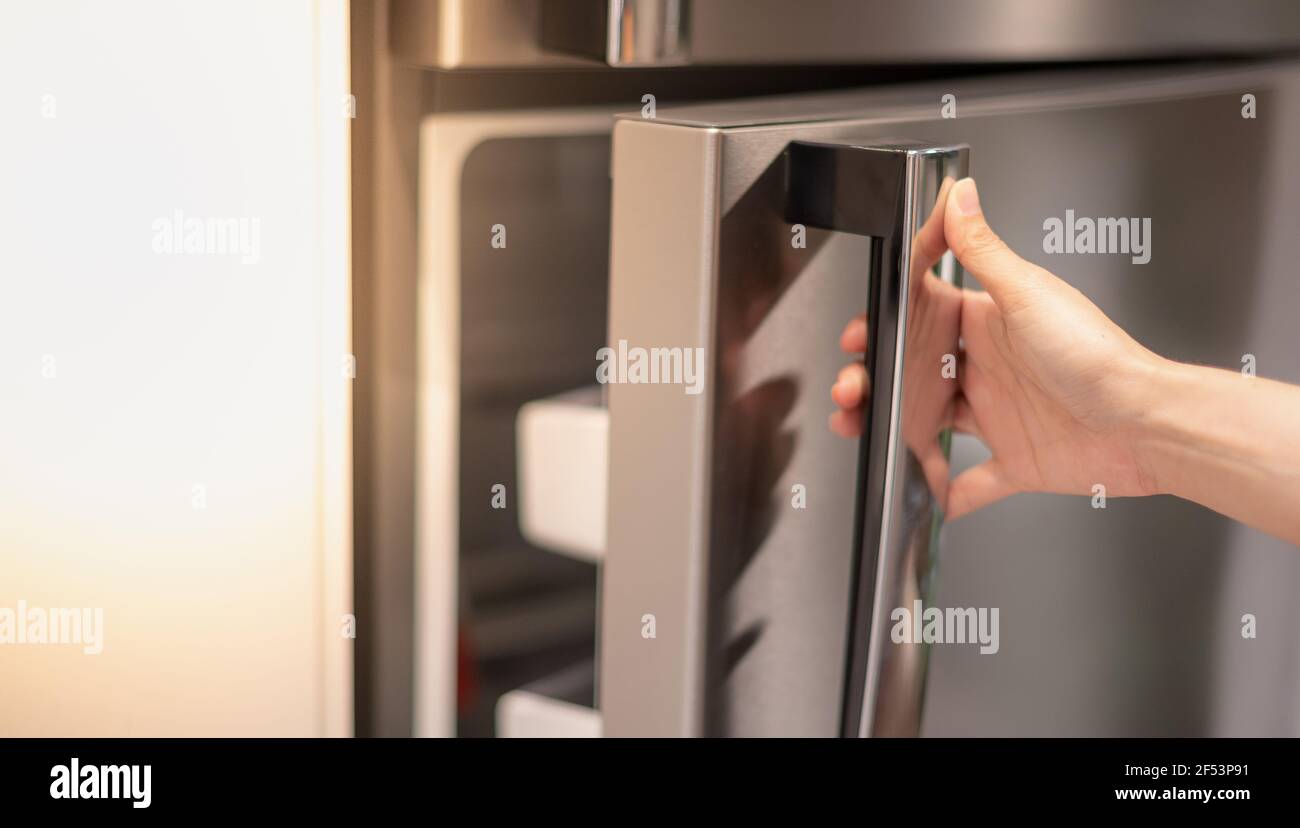Hand opening refrigerator hi-res stock photography and images - Alamy