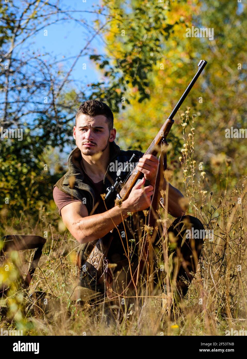 Hunter with rifle ready to hunting nature background. Hunting skills ...