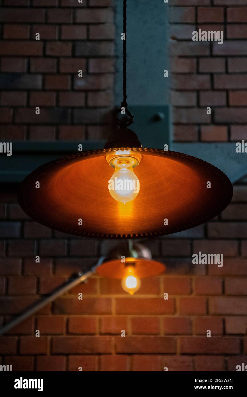 Old dim light in an old factory beside a brick wall Stock Photo - Alamy