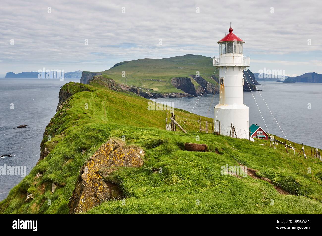 Mykines lighthouse and cliffs on Faroe islands. Hiking landmark ...
