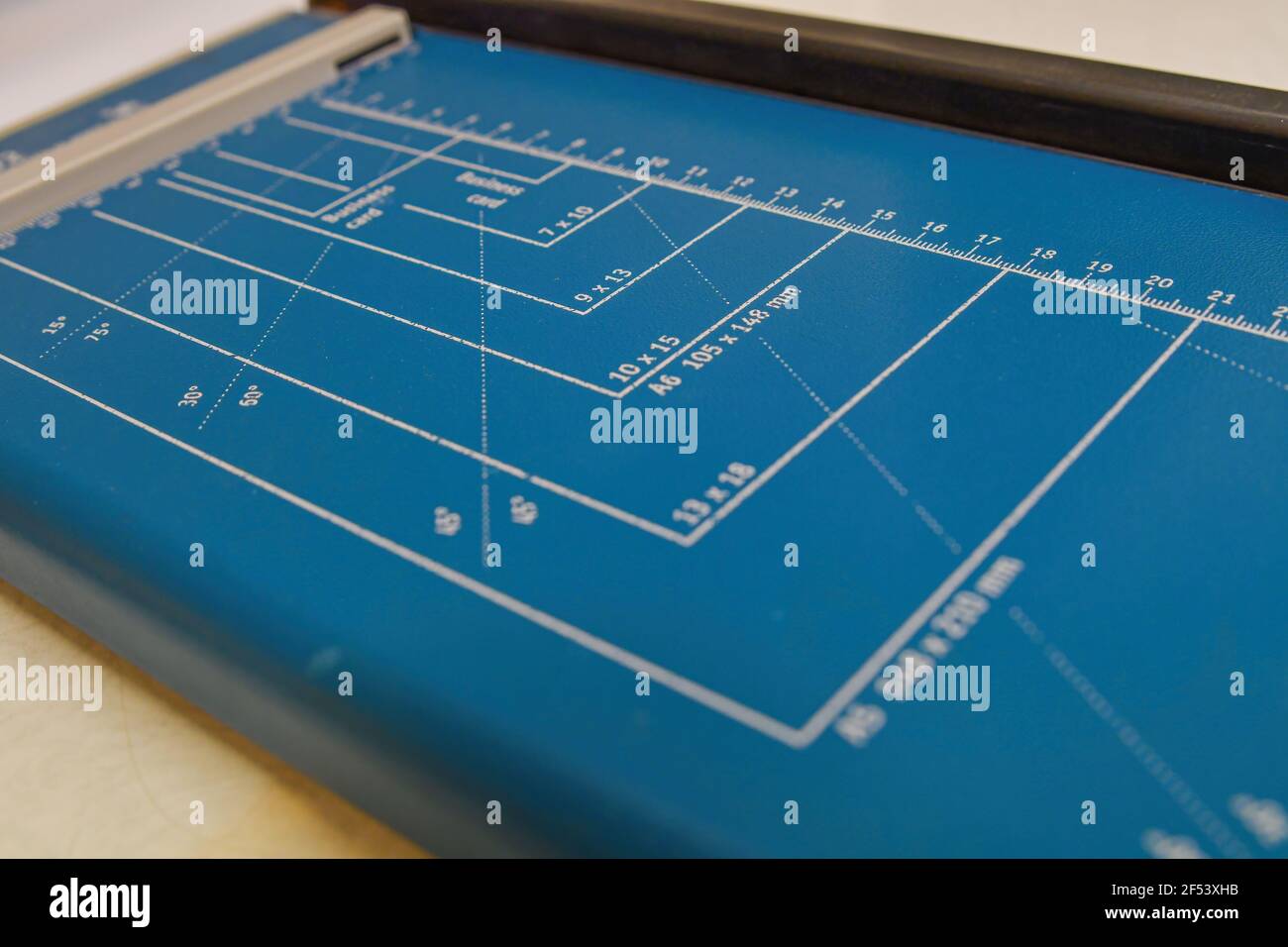 A blue paper cutter showing graduated paper sizes Stock Photo - Alamy