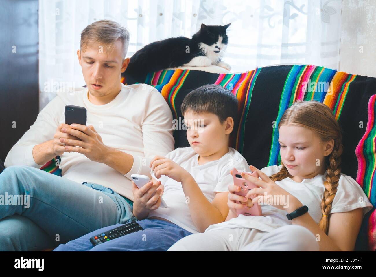 Happy alone dad looking at phone screen with children kids. smiling ...