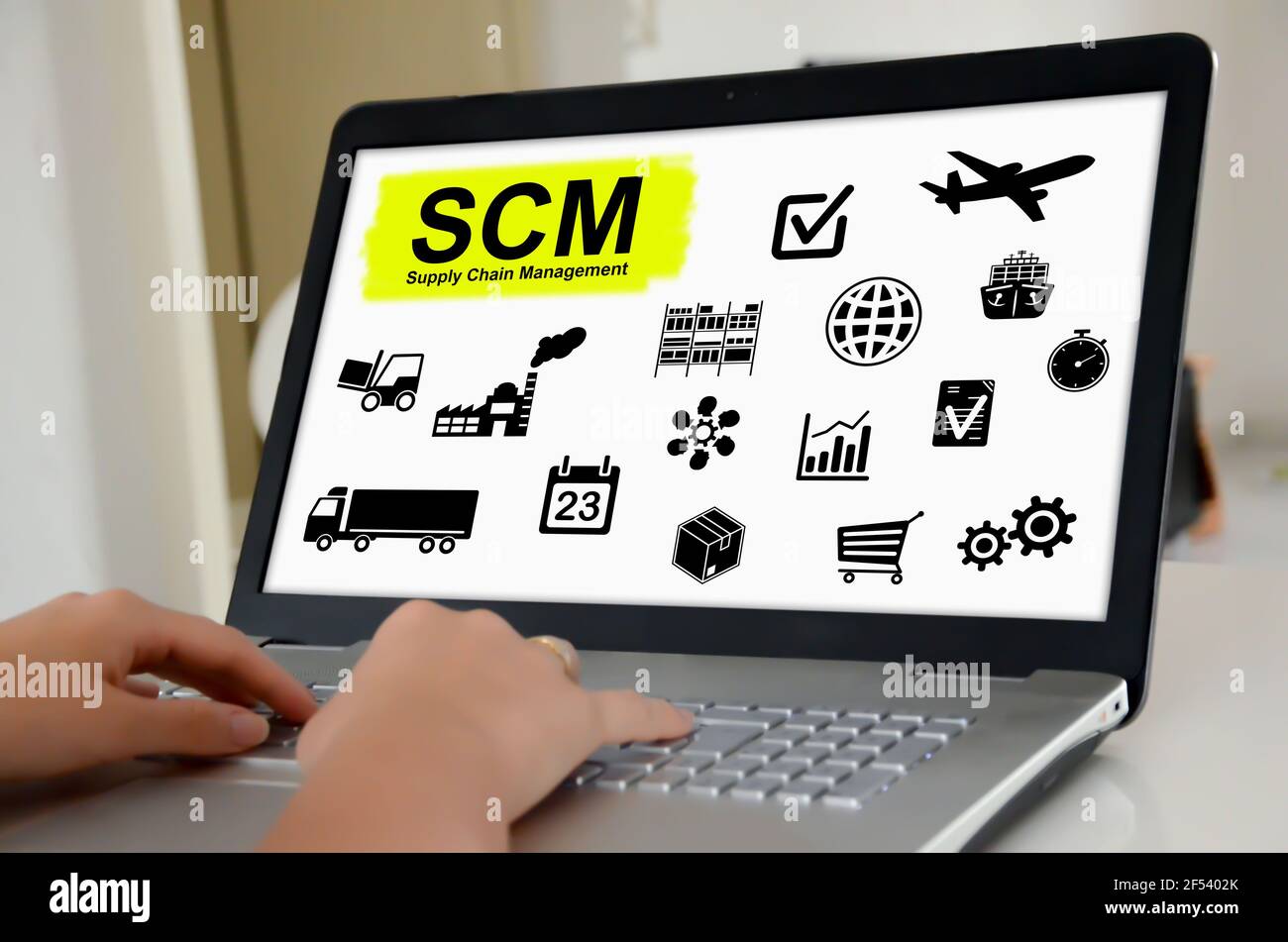 Hands on a laptop with screen showing scm concept Stock Photo - Alamy