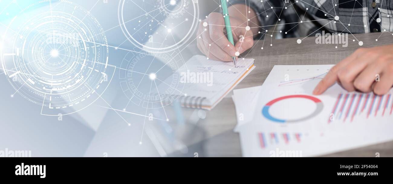 Businesswoman analyzing marketing data and taking notes; panoramic ...