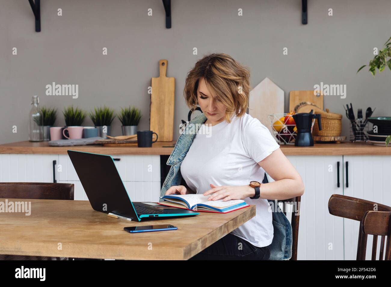 Remote Working From Home. Girl Freelancer Workplace In Kitchen With ...