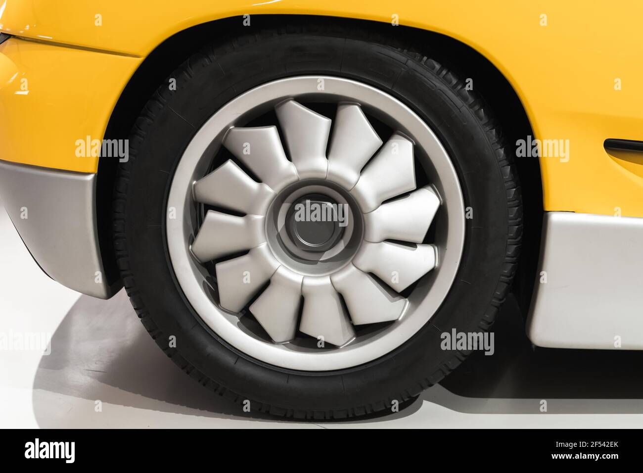 Yellow sports car wheel on light alloy rim, close up photo. Abstract ...