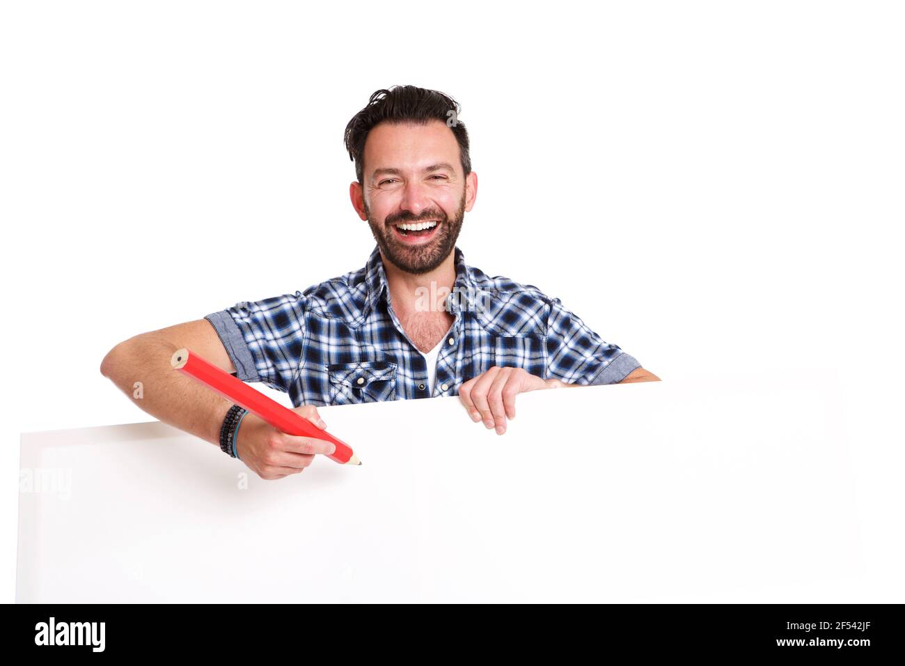 Portrait of laughing mature man writing over blank poster against white ...