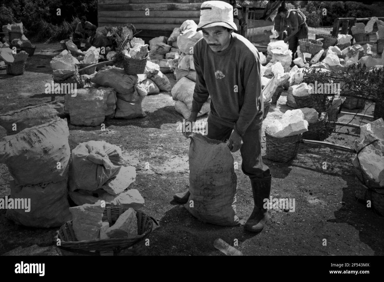 A sulfur miner packing his loads at the final check point of the sulfur ...