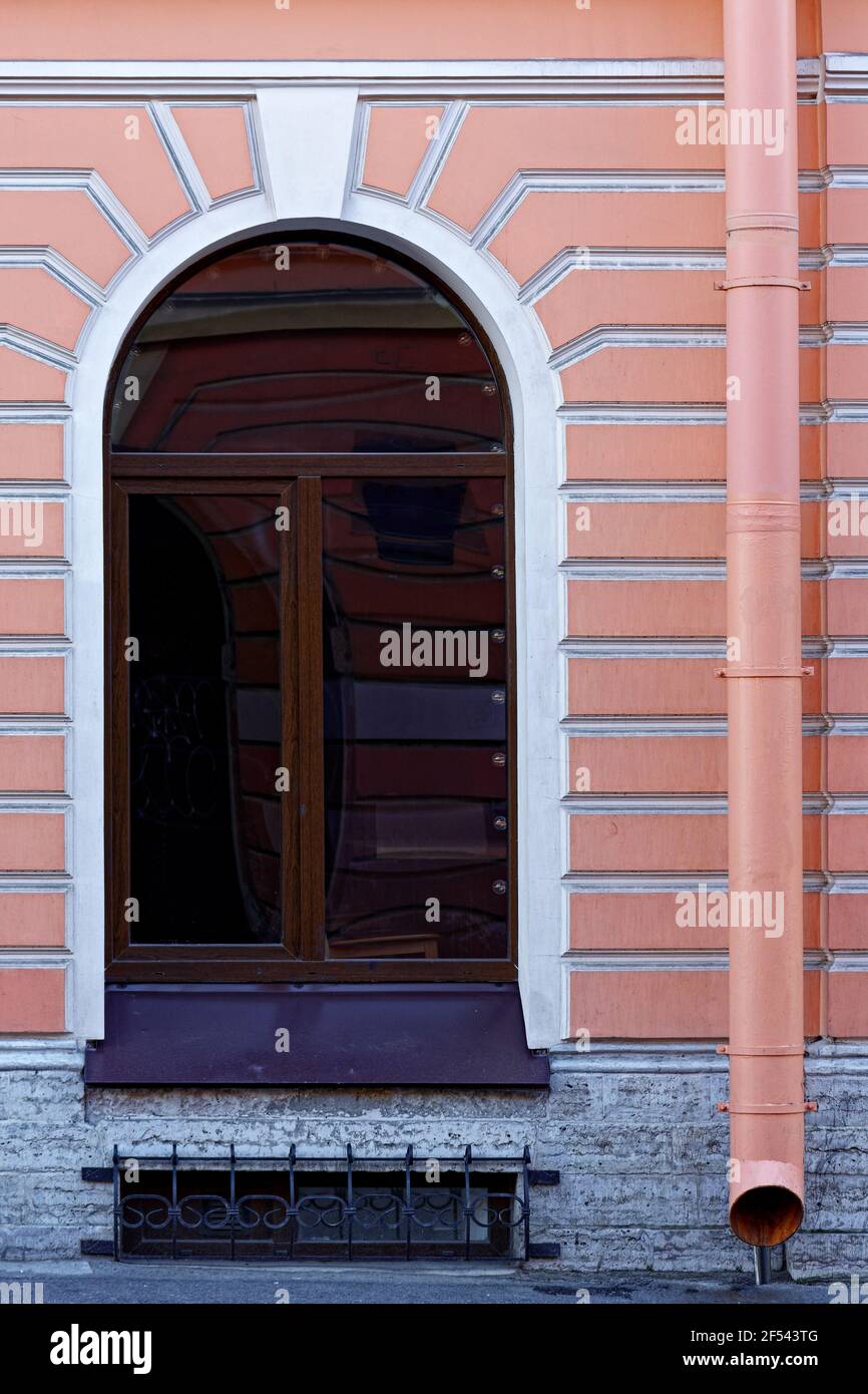 Arched window against a pink plastered wall. From a series of windows ...