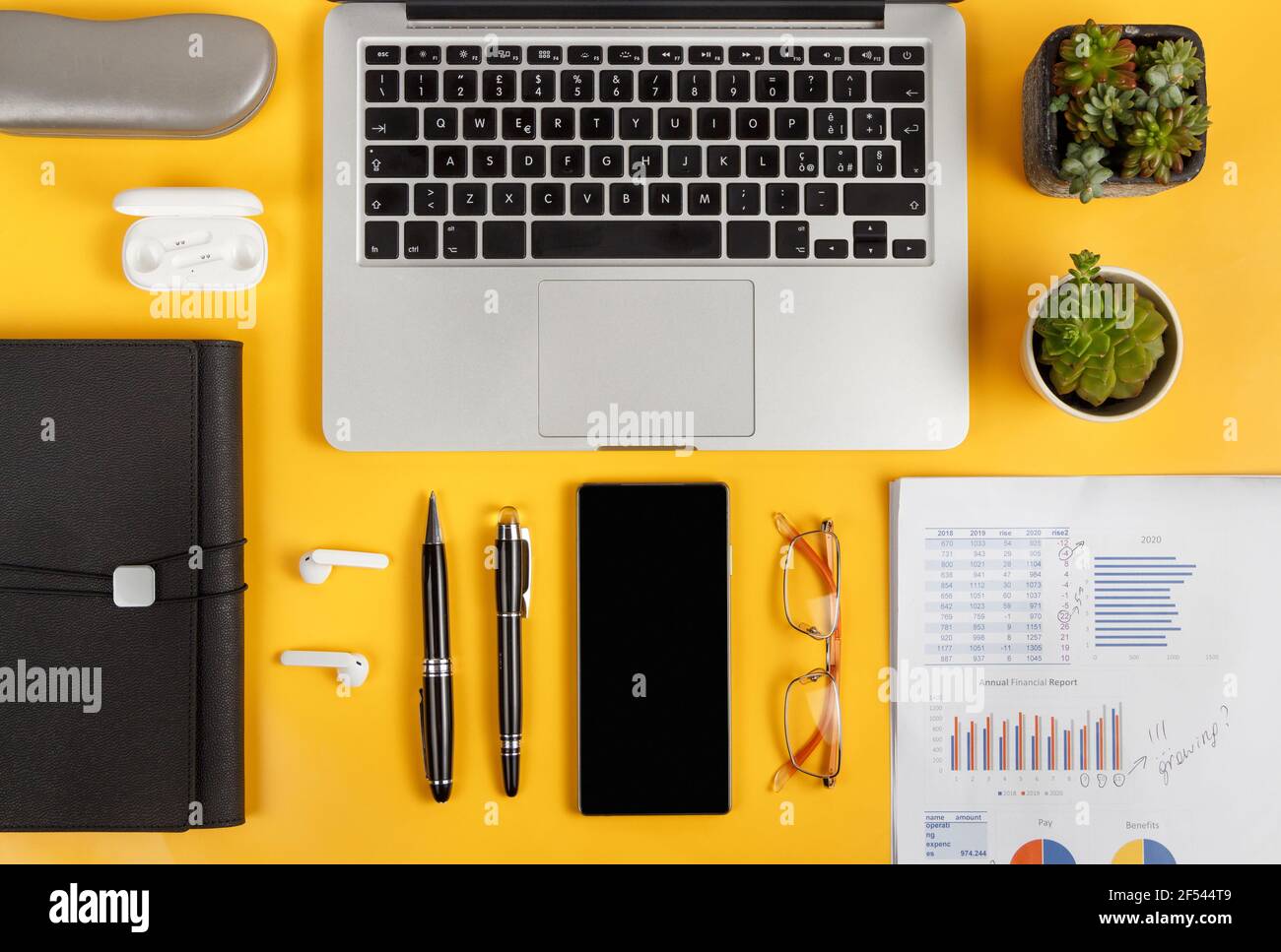 Cell phone and modern gadgets on a yellow background top view. Business ...