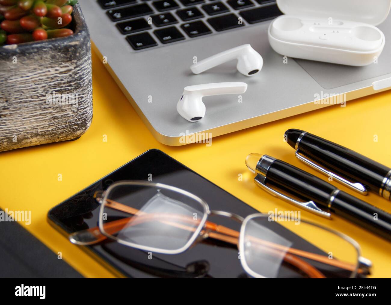 Cell phone and modern gadgets on a yellow background close up. Business ...