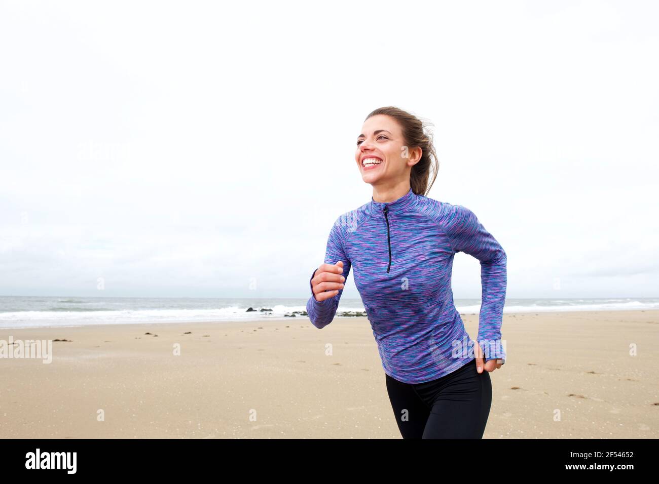 Happy woman running on beach hi-res stock photography and images - Alamy