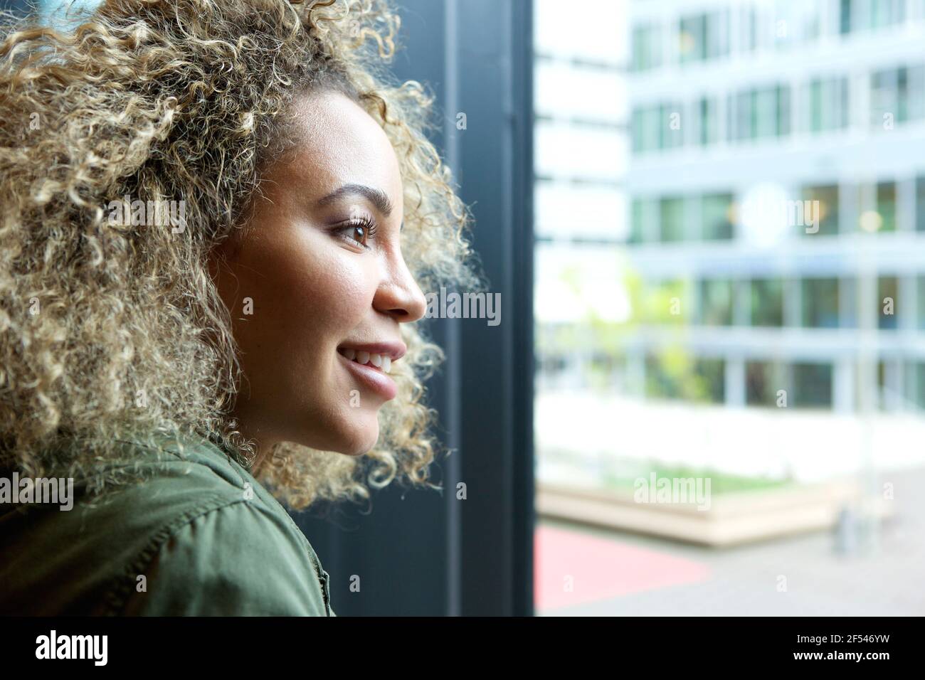 Side profile close up of beautiful woman looking out window Stock Photo ...