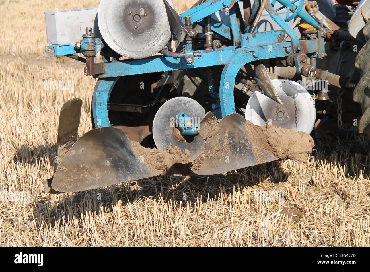 The Mud Covered Blades of a Vintage Farming Plough Stock Photo - Alamy