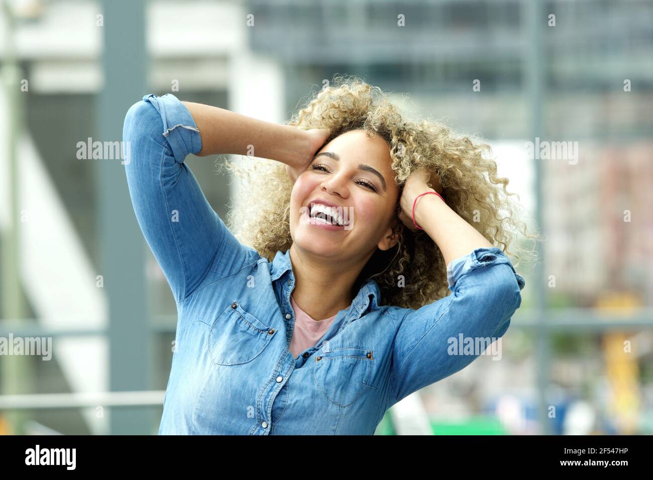 Portrait curly model laughing indoors hi-res stock photography and ...