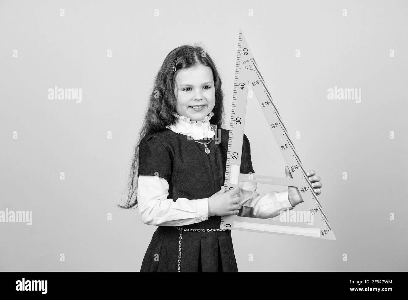 School student learning geometry. Pupil girl with big ruler. STEM ...