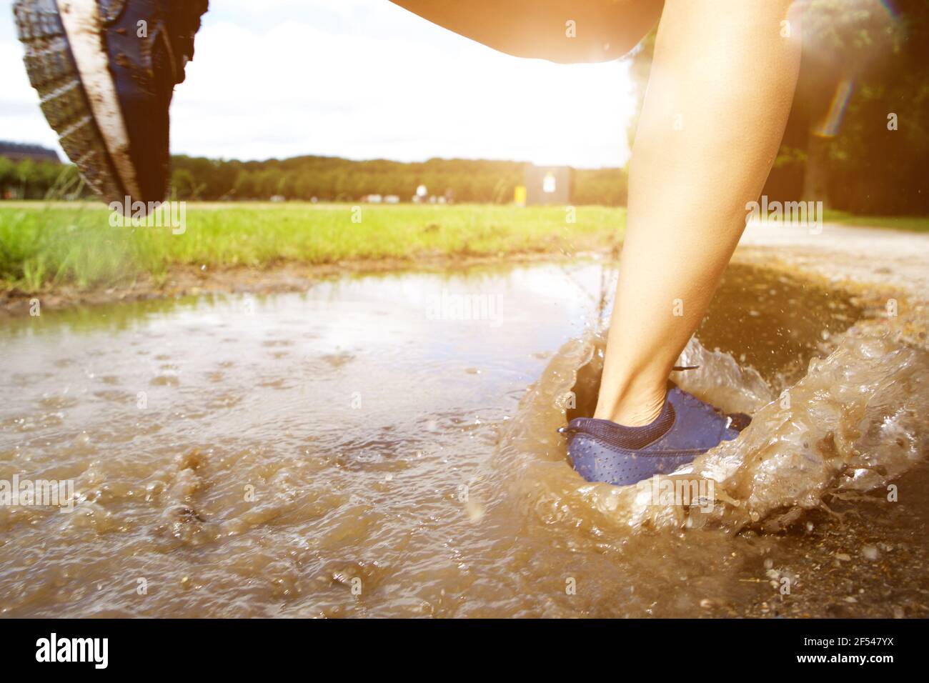 Close up portrait of runner's feet in mud puddle Stock Photo - Alamy