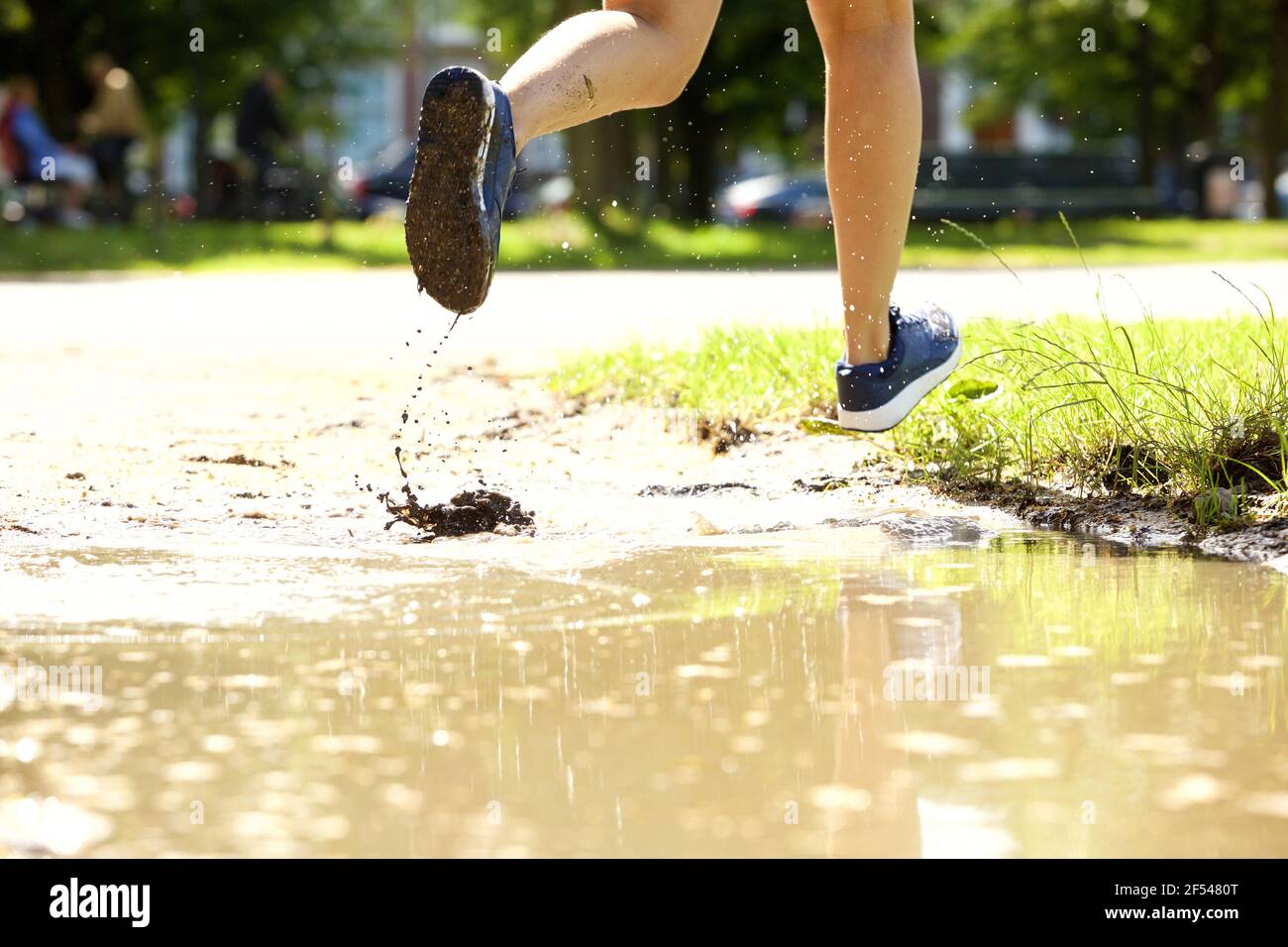 Close up portrait of female runner in mud puddle Stock Photo - Alamy