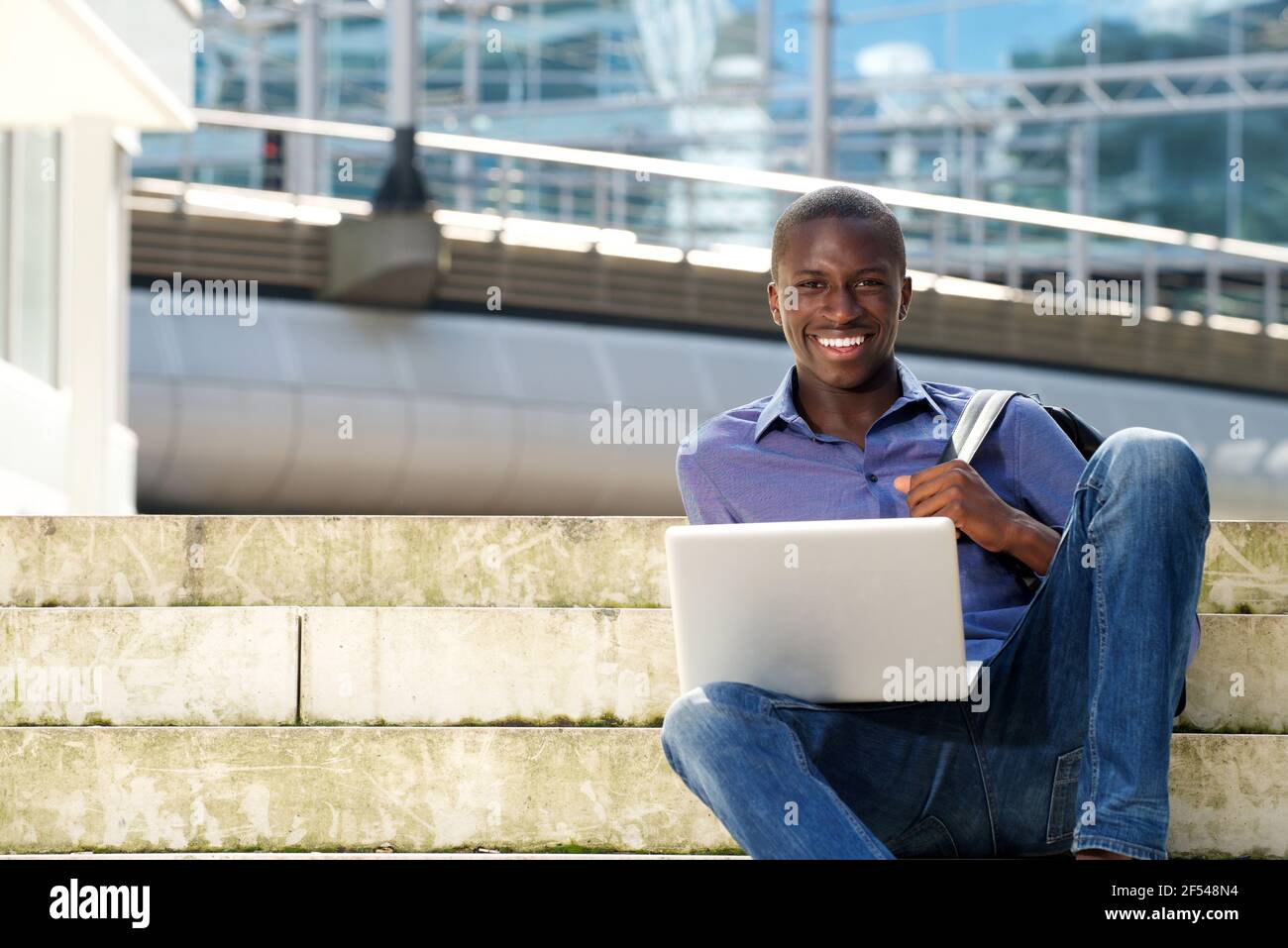 Smiling student sitting on steps hi-res stock photography and images ...
