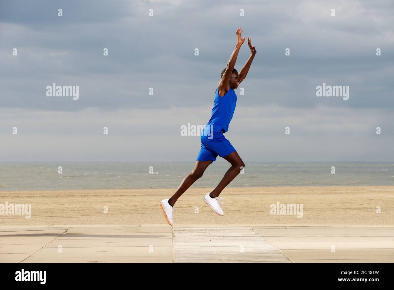 Full body side portrait of fit young african american man jogging at ...
