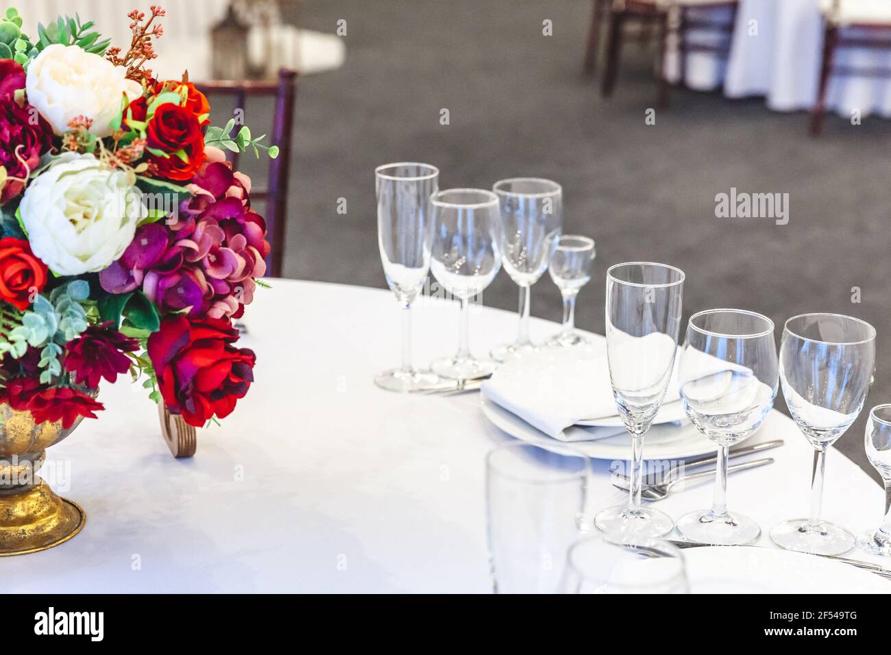 Fancy table set for dinner with flower composition in restaurant ...