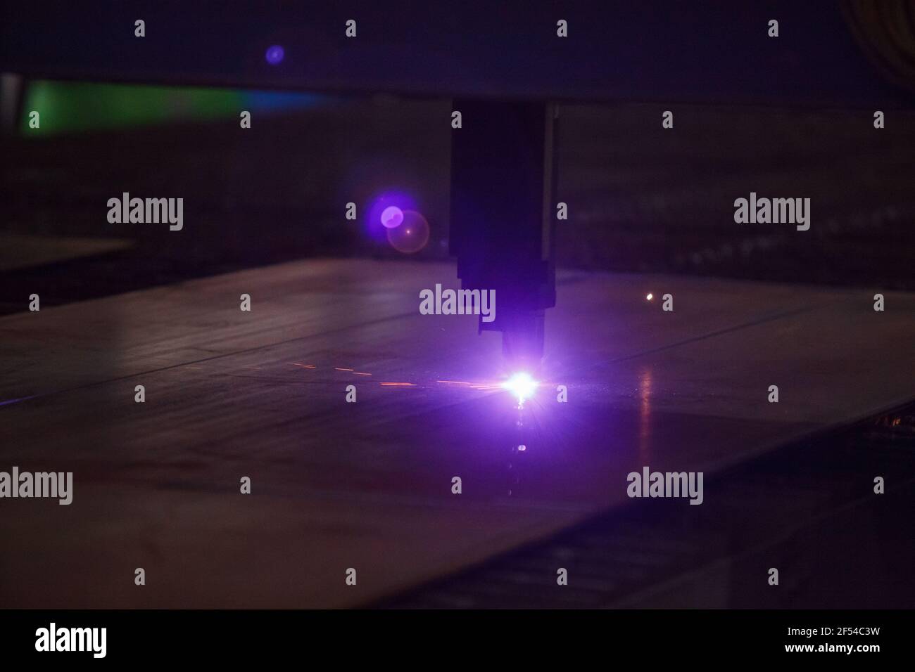 Laser cutting CNC machine. Blue laser beam and sparks. Train car ...