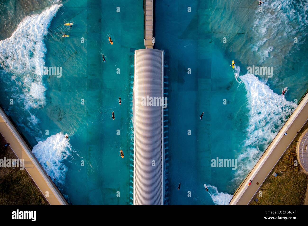Surfers ride waves during a training session for staff at The Wave ...