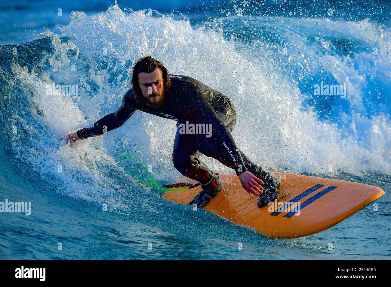 A surfer rides a wave during a training session for staff at The Wave ...