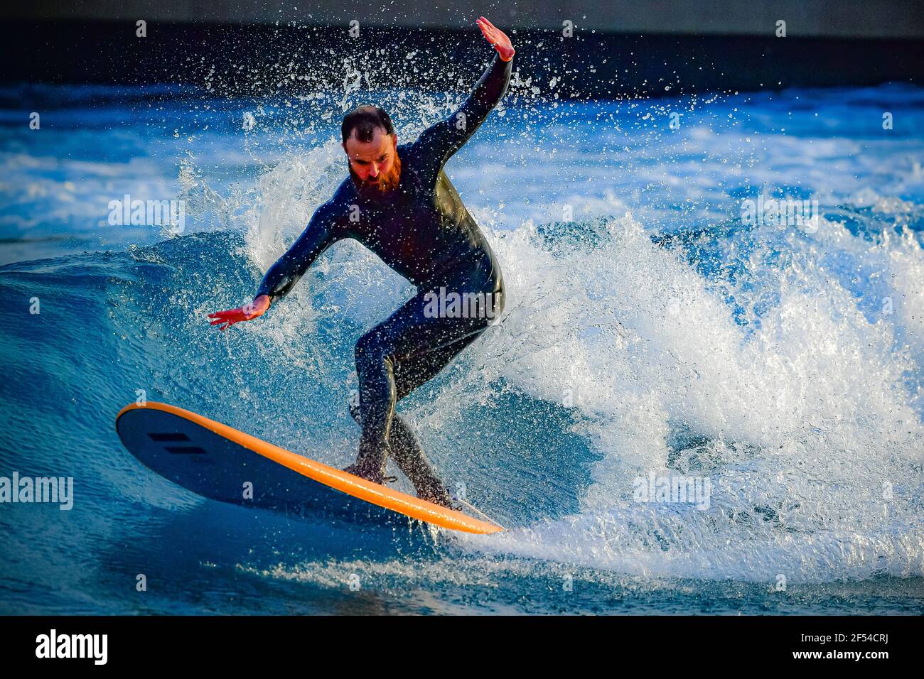 A surfer rides a wave during a training session for staff at The Wave ...