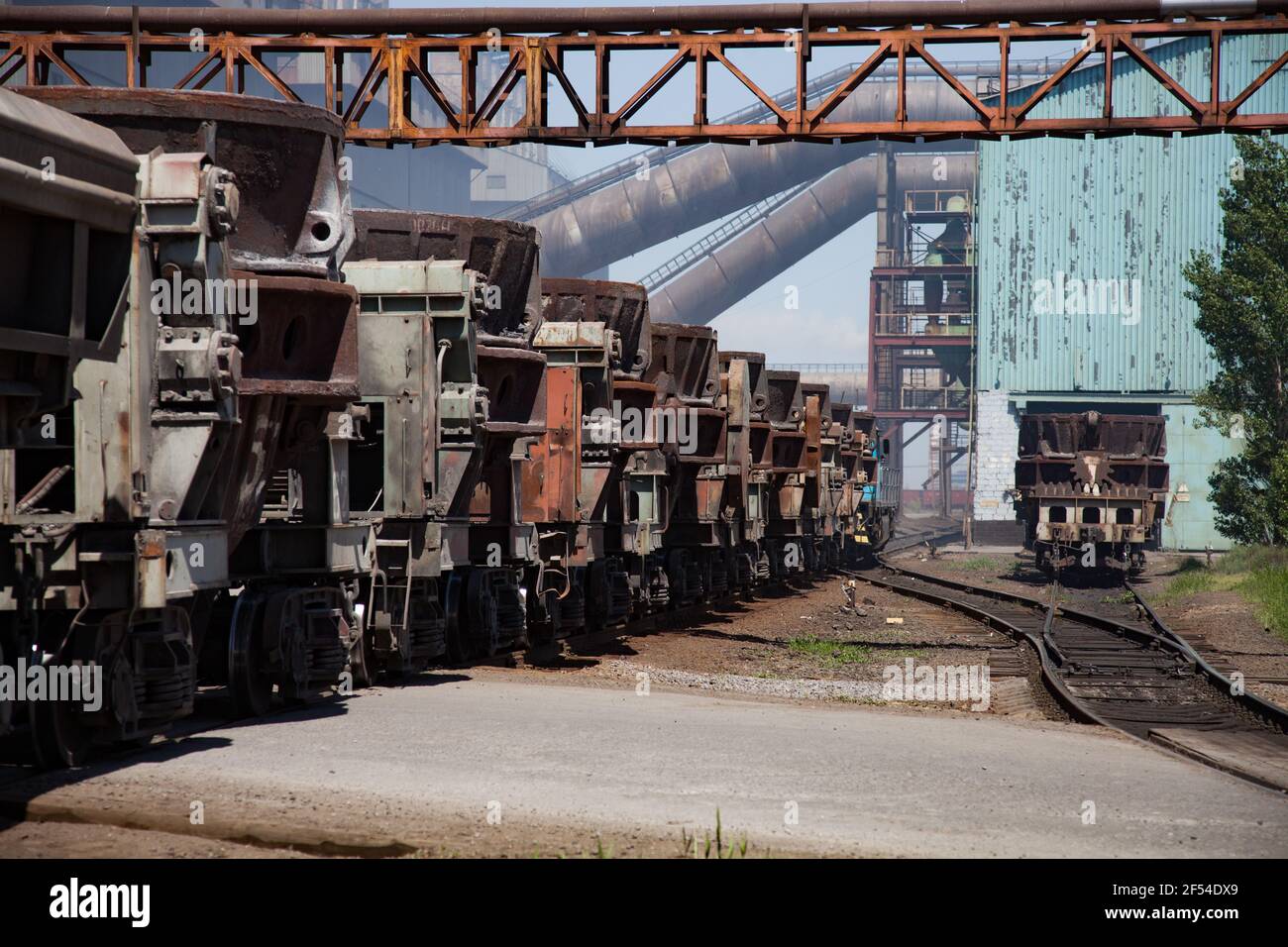 Metal alloys plant. Rusted slag cars wagon on rails. Metallurgical ...