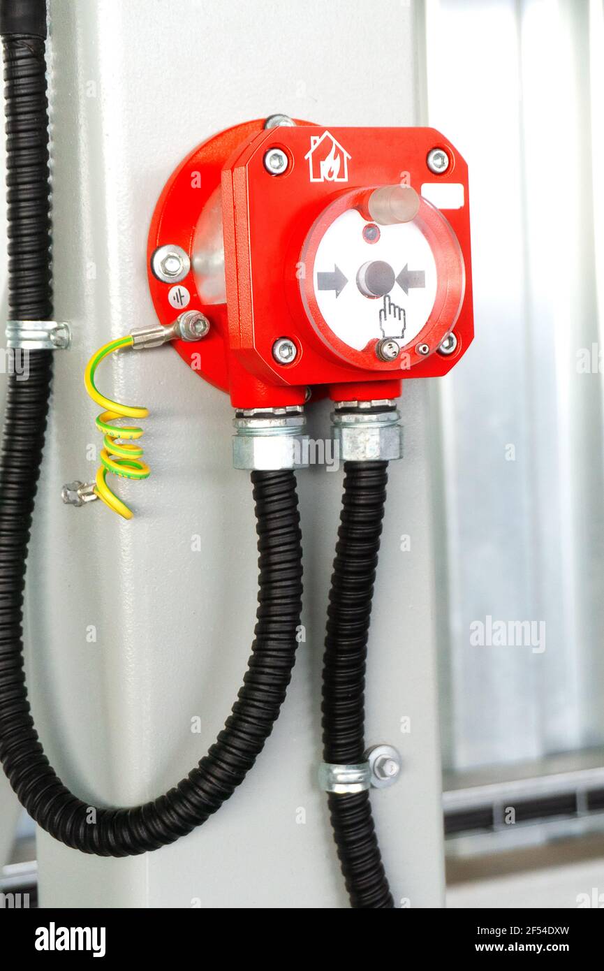 Fire alarm button in industrial room metal hangar Stock Photo - Alamy