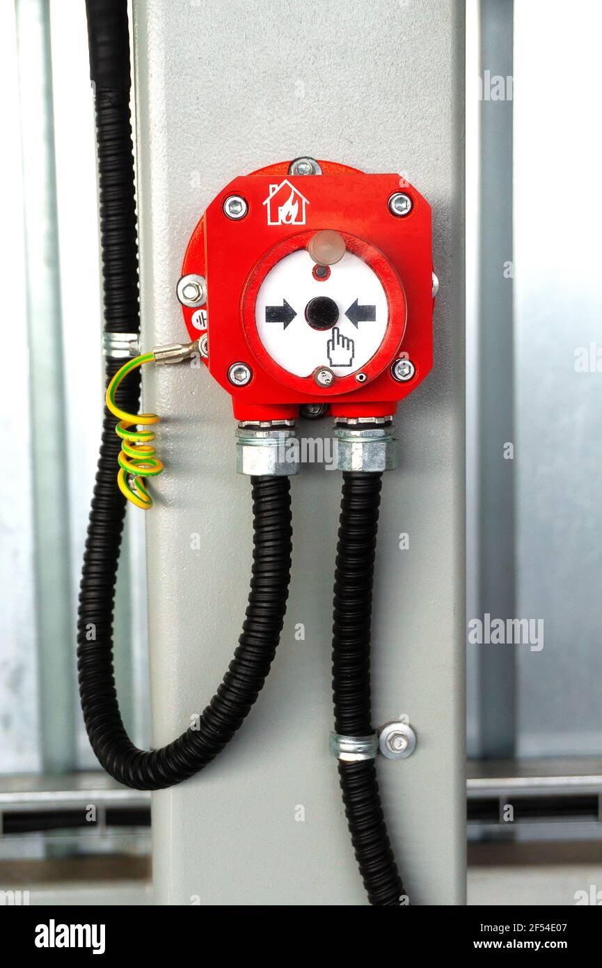 Fire alarm button in industrial room metal hangar Stock Photo - Alamy