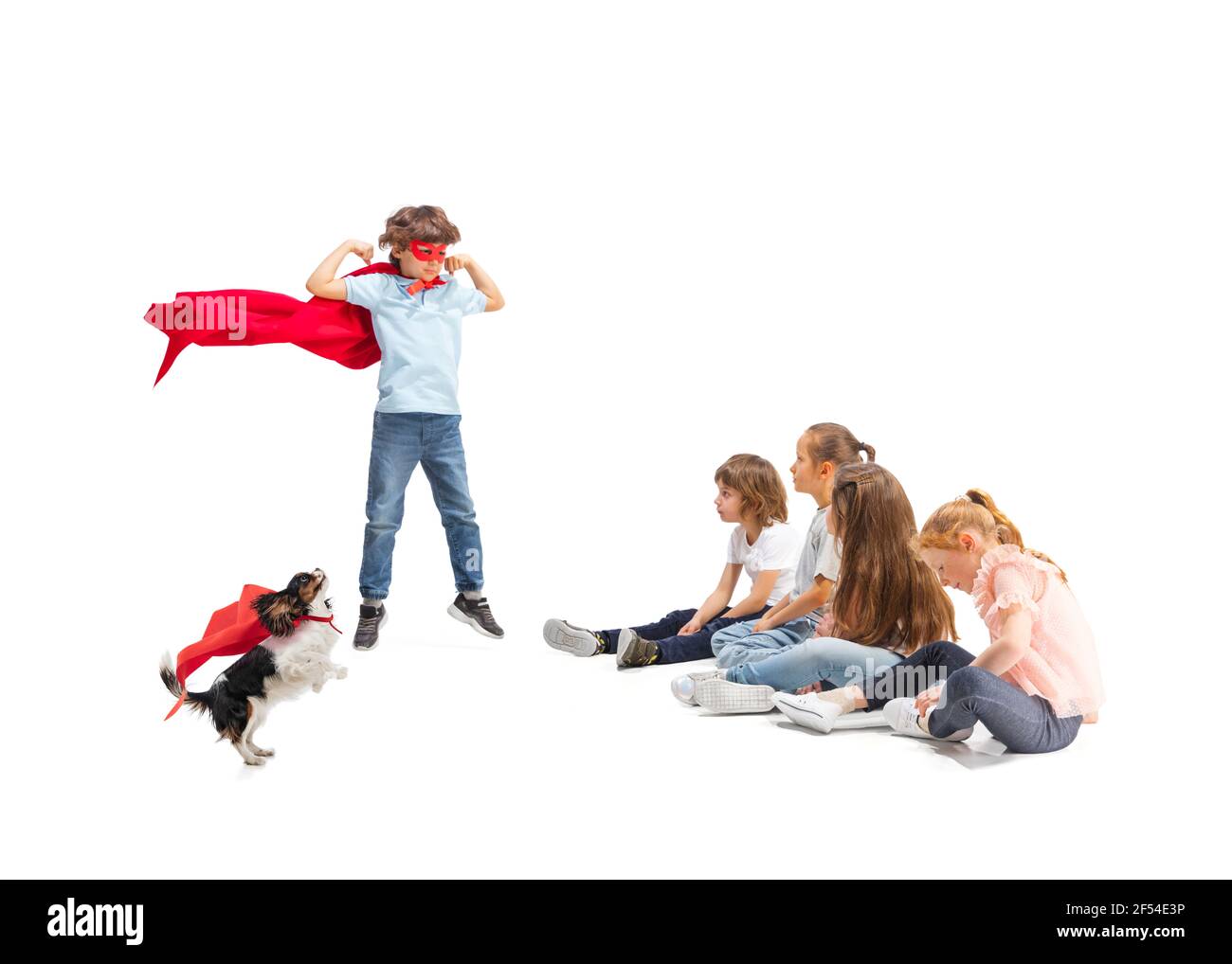 Child pretending to be a superhero with his super dog and friends ...