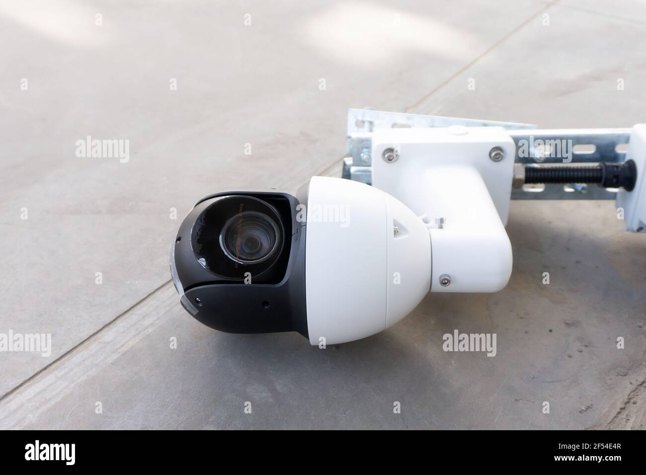 a rotary video camera for street surveillance lies on the ground ready ...