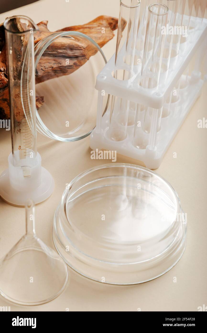 Laboratory glassware on color beige table. Chemical laboratory research ...
