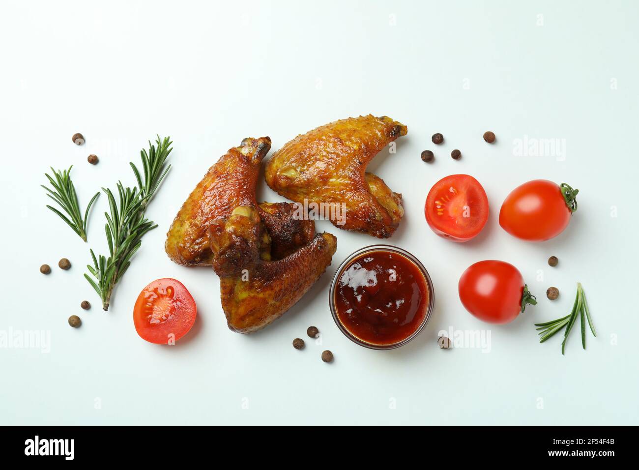 Baked chicken wings, spices and sauce on white background Stock Photo ...