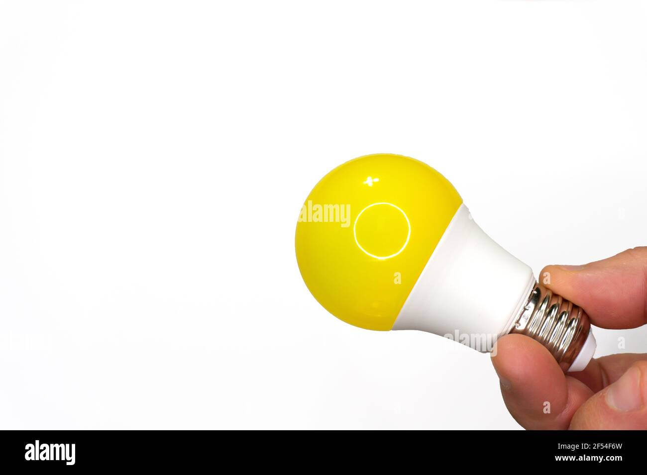 modern yellow led lamp in hand on white background Stock Photo - Alamy