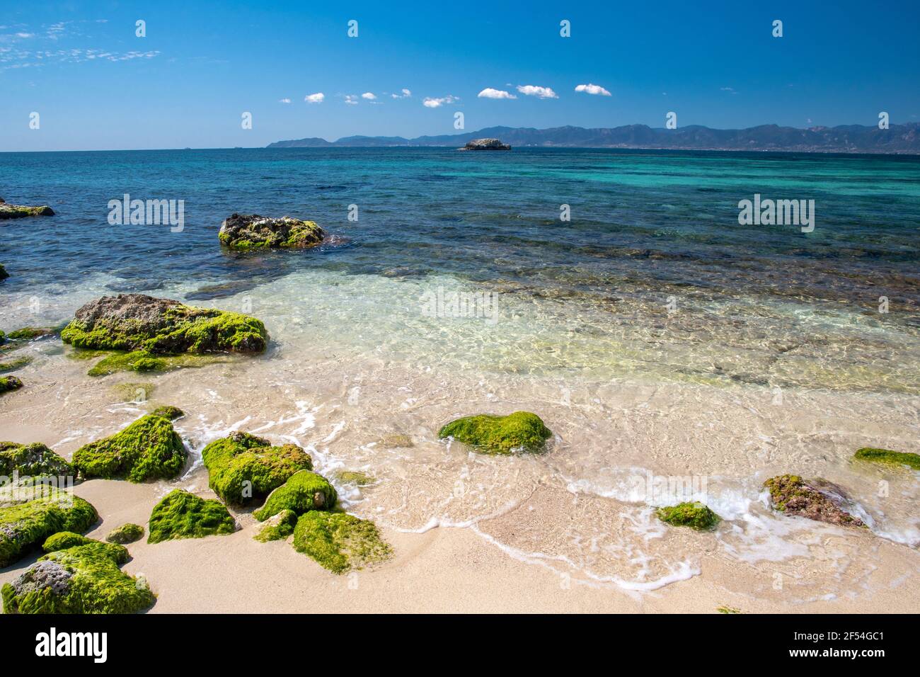Crystal clear water, rocks and white sand for background Stock Photo ...