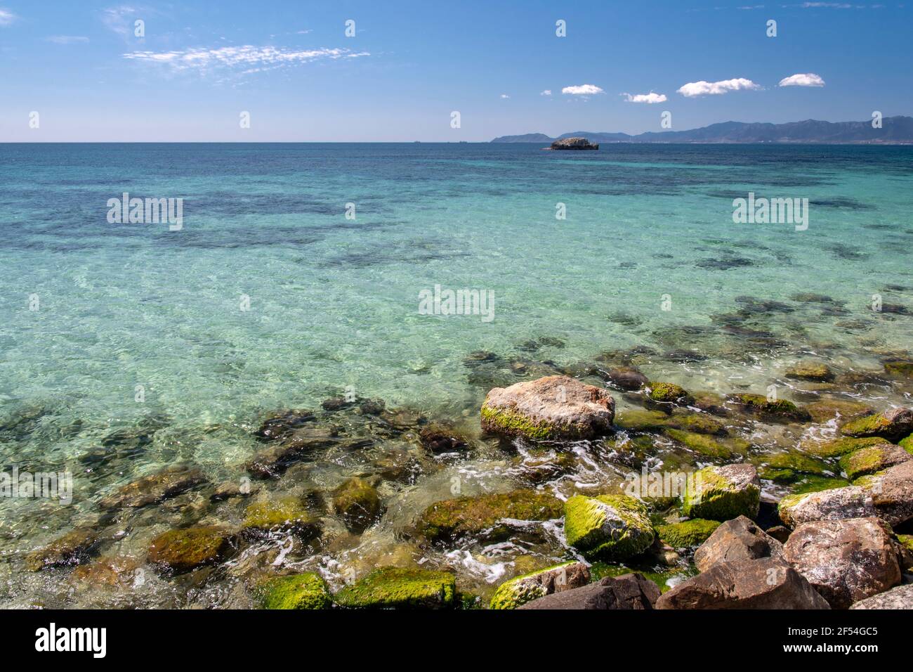Crystal clear water, rocks and white sand for background Stock Photo ...