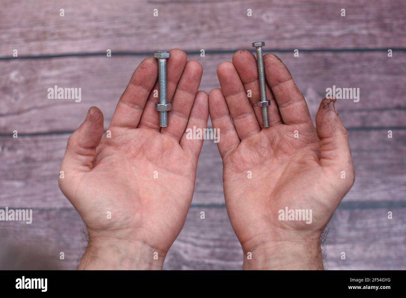Hands holding nuts bolts hi-res stock photography and images - Alamy