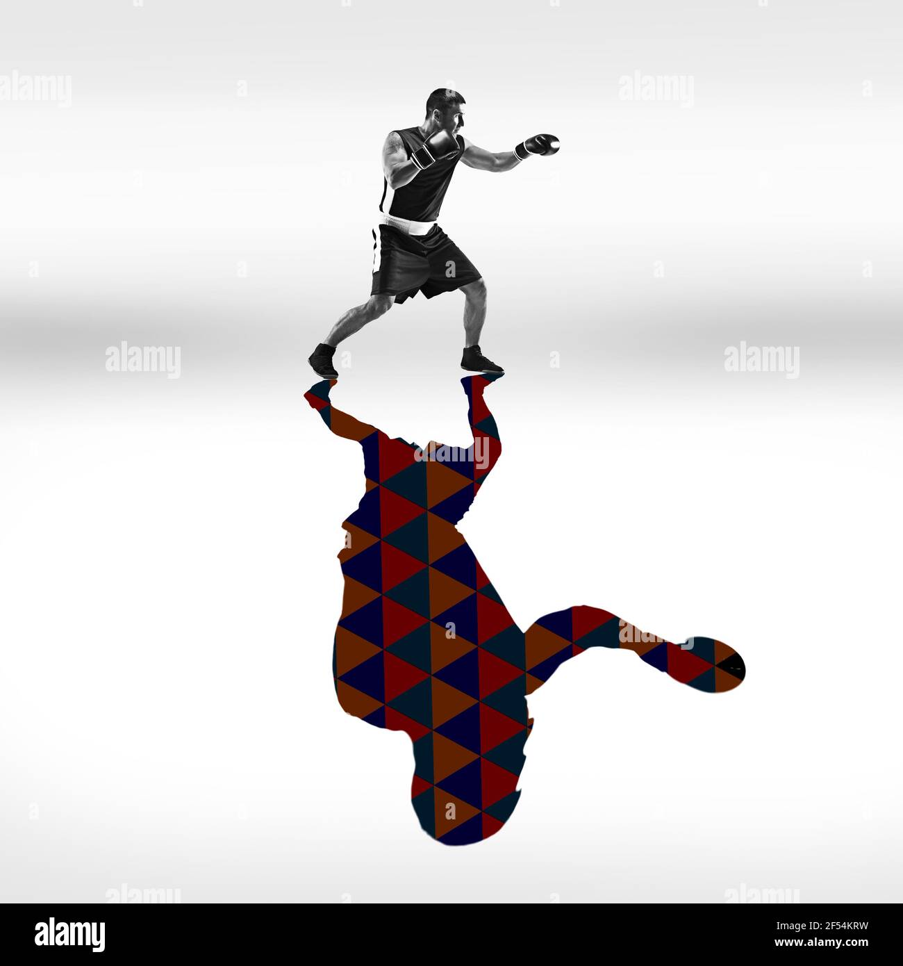 Young caucasian sportsman isolated on studio background with shadow ...