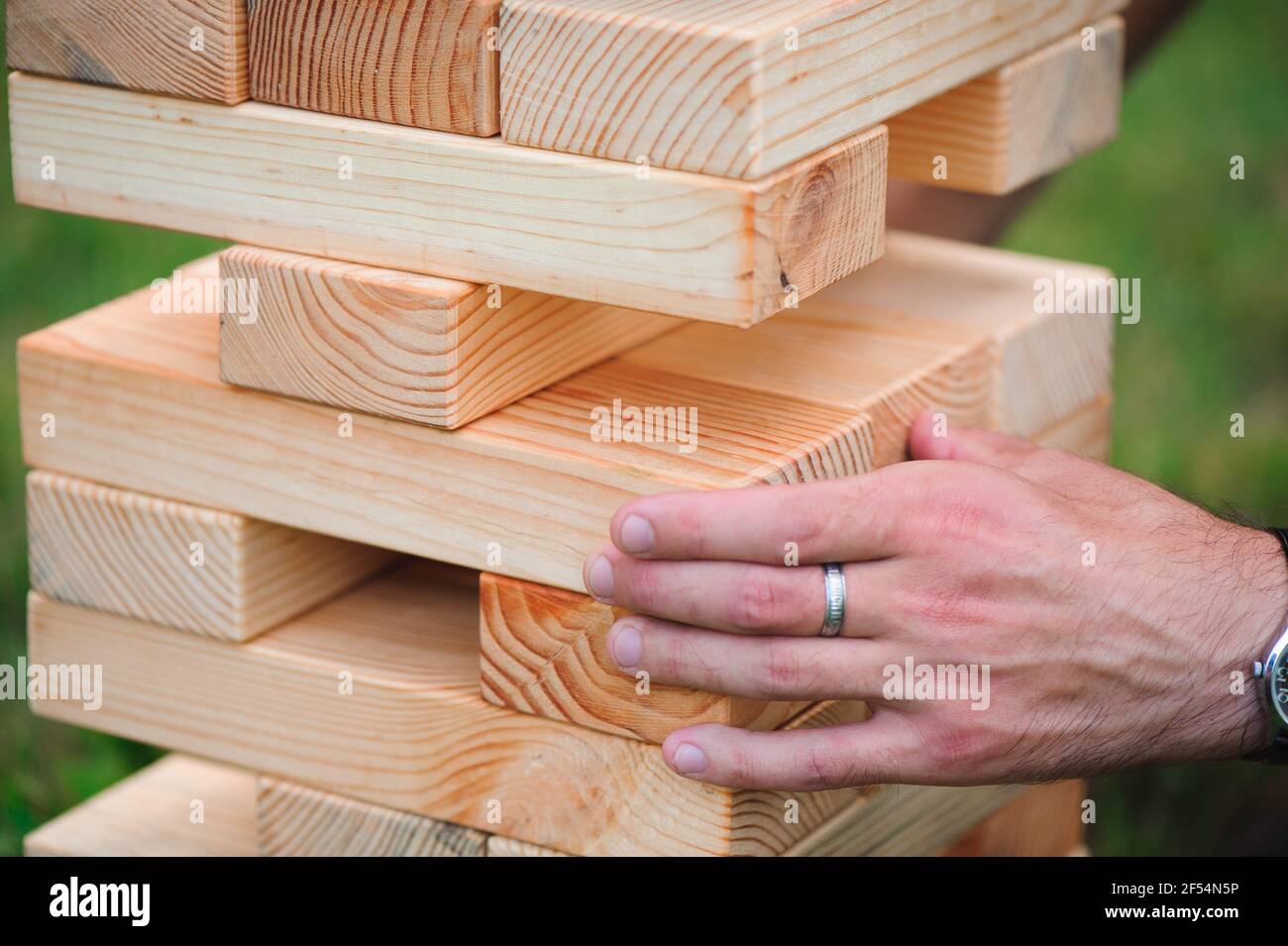 Close up blocks wood game on the green grass Stock Photo - Alamy