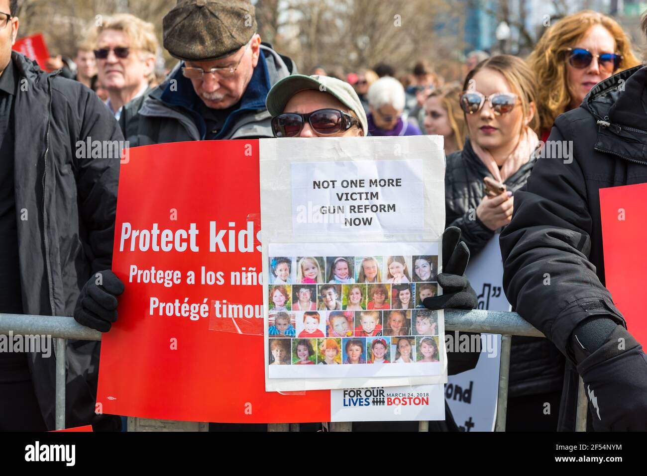 A woman in a crowd of people holding a sign at the March for Our Lives ...