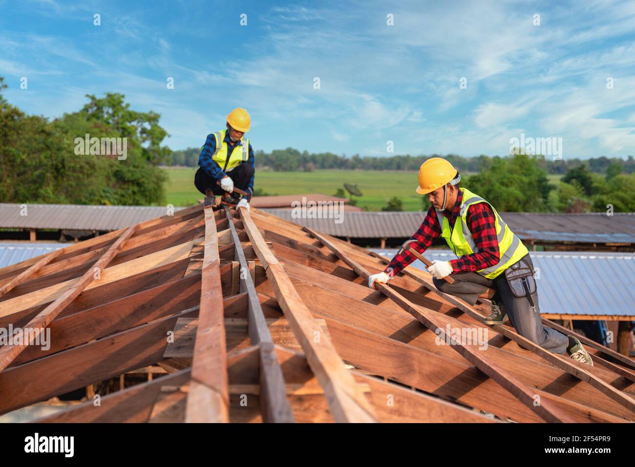 Roofer, Two worker roofer builder working on roof structure on ...
