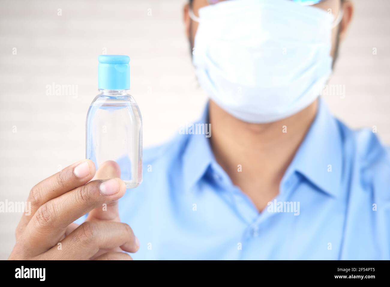 Using sanitizer liquid for preventing corona virus Stock Photo - Alamy
