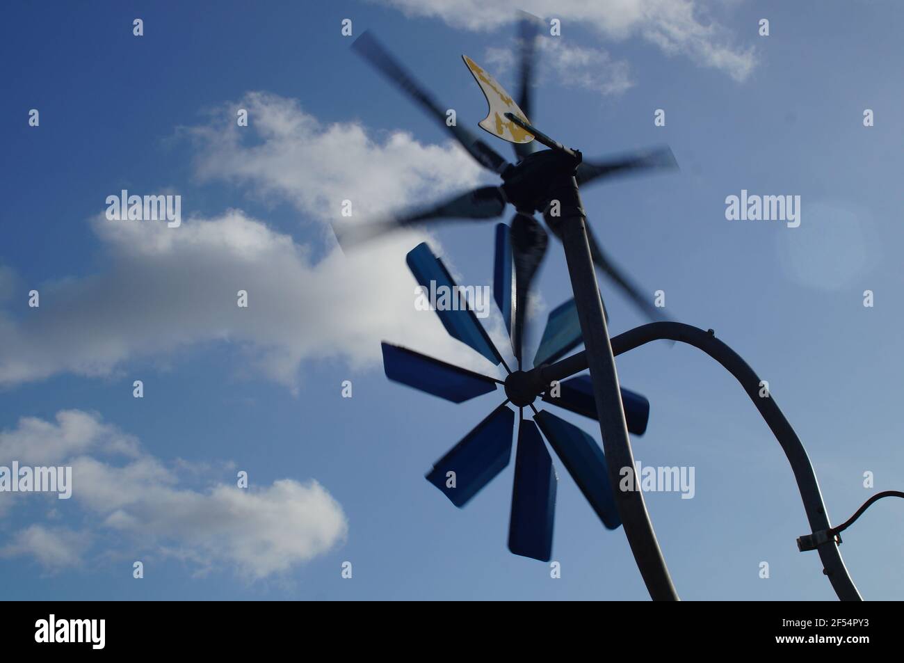 Two wind wheels of different speed before a cloudy sky Stock Photo - Alamy