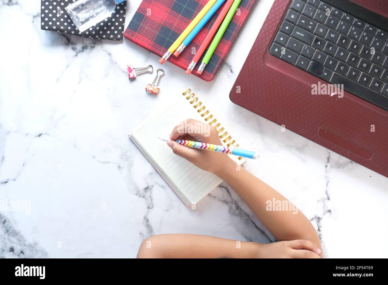 top view of child girl hand writing on notepad Stock Photo - Alamy