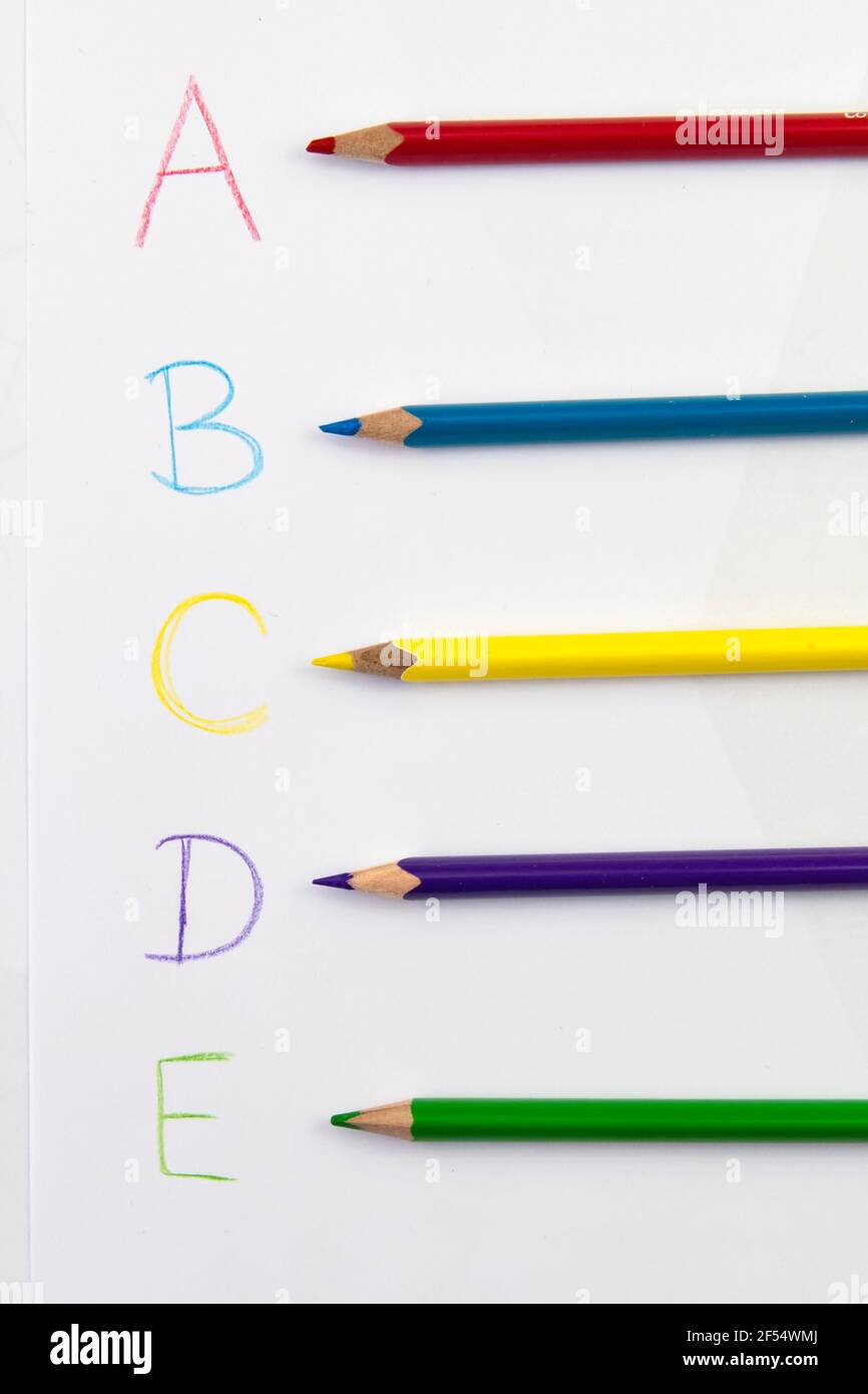 Learning colors and letters with color pencils on white paper Stock ...