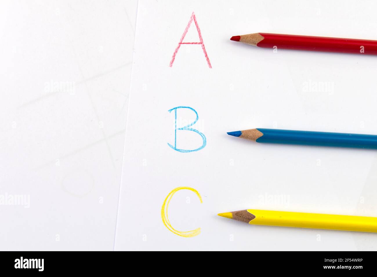 Learning colors and letters with color pencils on white paper Stock ...