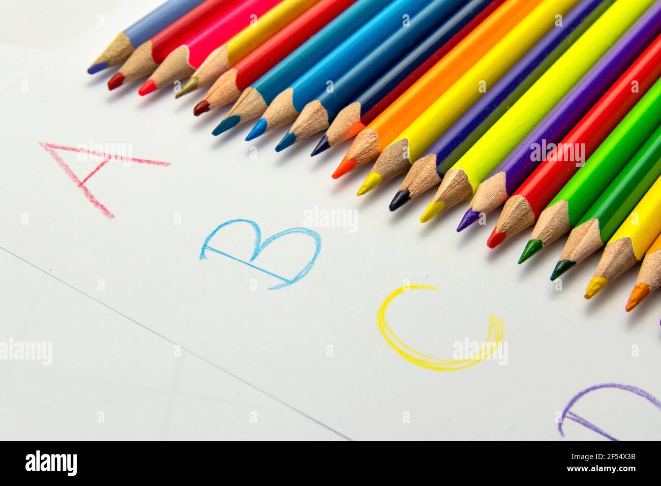 Learning colors and letters with color pencils on white paper Stock ...